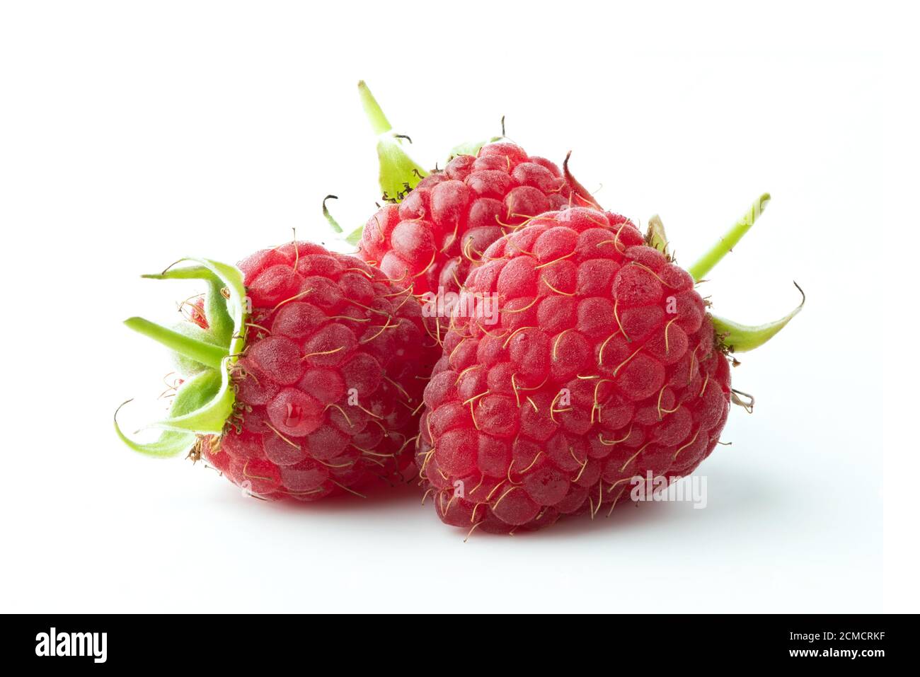 Three ripe raspberry fruits with green stems isolated on white ...