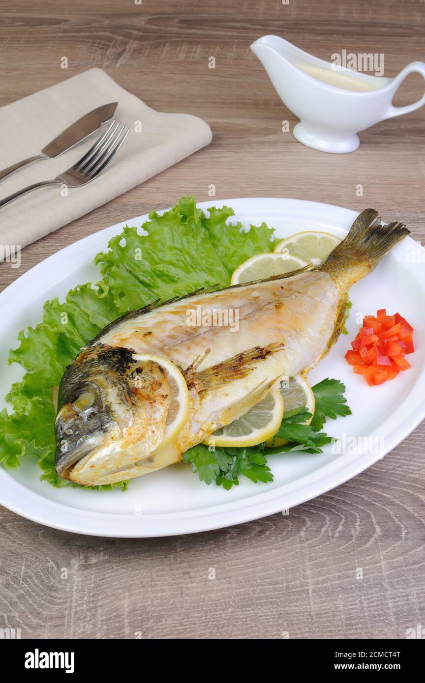 Baked fish Dorado Stock Photo - Alamy