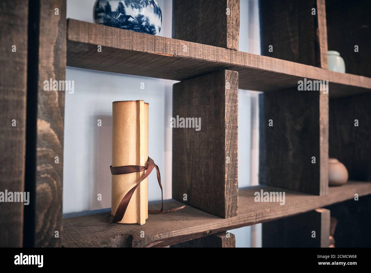 Chinese paper scroll and traditional teaware on the shelves in the tea ...