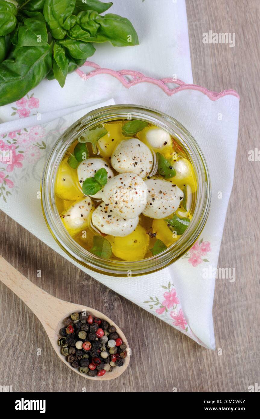 Baby mozzarella in oil with spices Stock Photo - Alamy