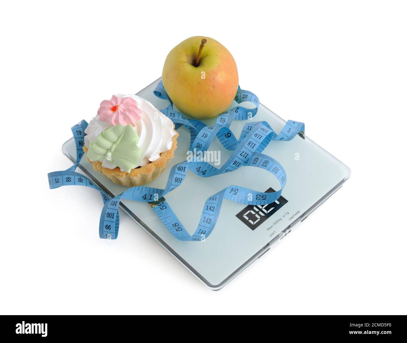 Cake and apple on scales measuring tape wrapped Stock Photo - Alamy