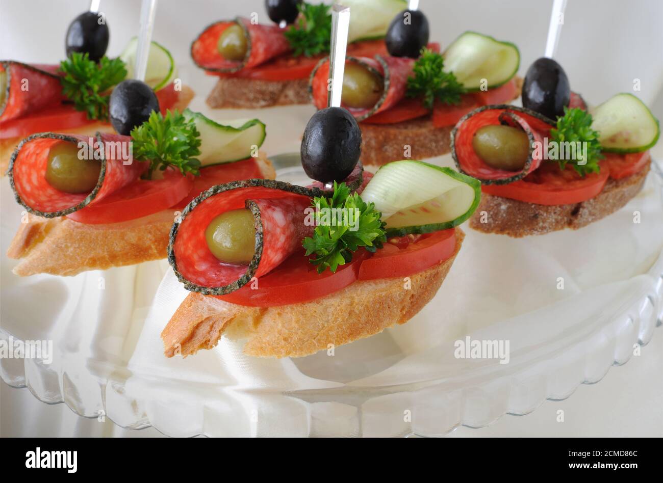 Canapés with salami Stock Photo - Alamy