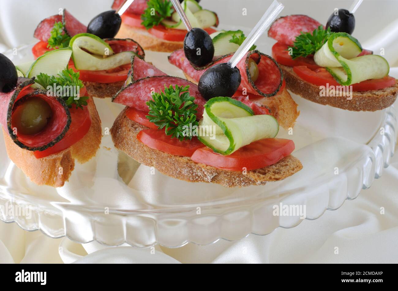 Canapés with salami Stock Photo - Alamy