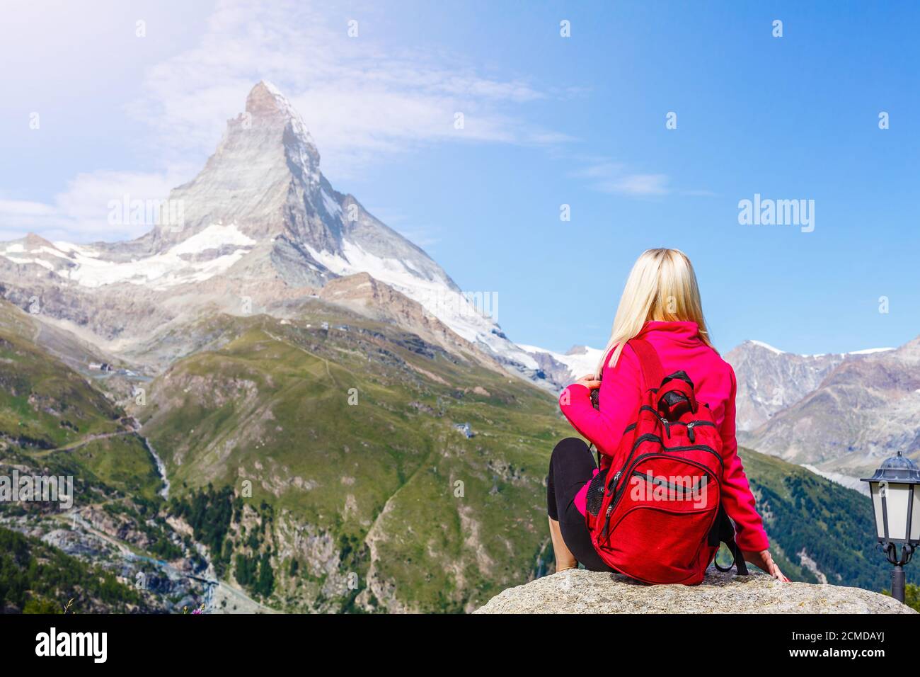 Woman hikers in the Alps, Matterhorn peak in Switzerland Stock Photo ...