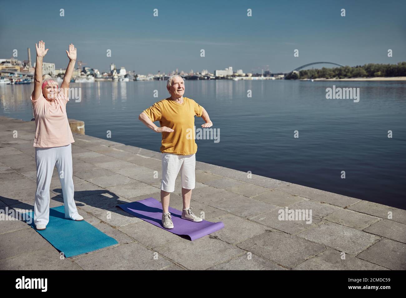 Man and his cheerful wife training together Stock Photo - Alamy