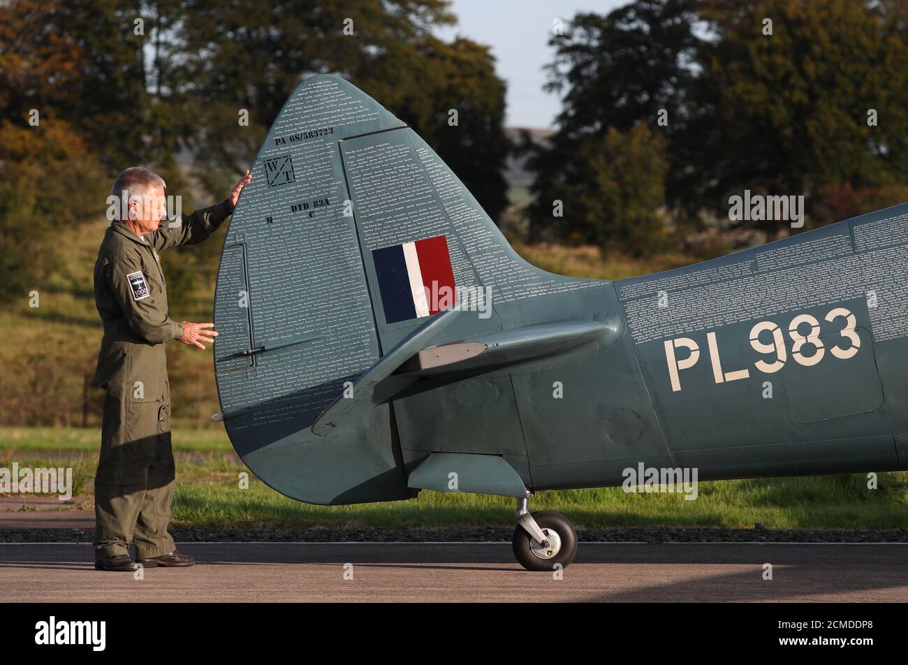 Pilot John Romain views hand written signatures on the fuselage of the ...