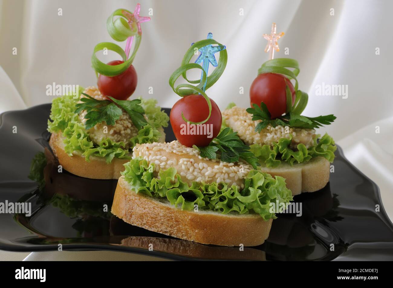 Canapes of chicken with sesame Stock Photo - Alamy