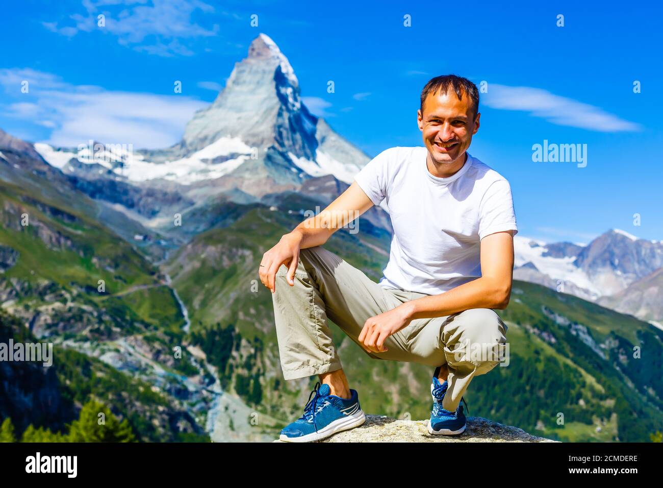 Hiker poses in front of mountain peaks range hiking backpacker old ...