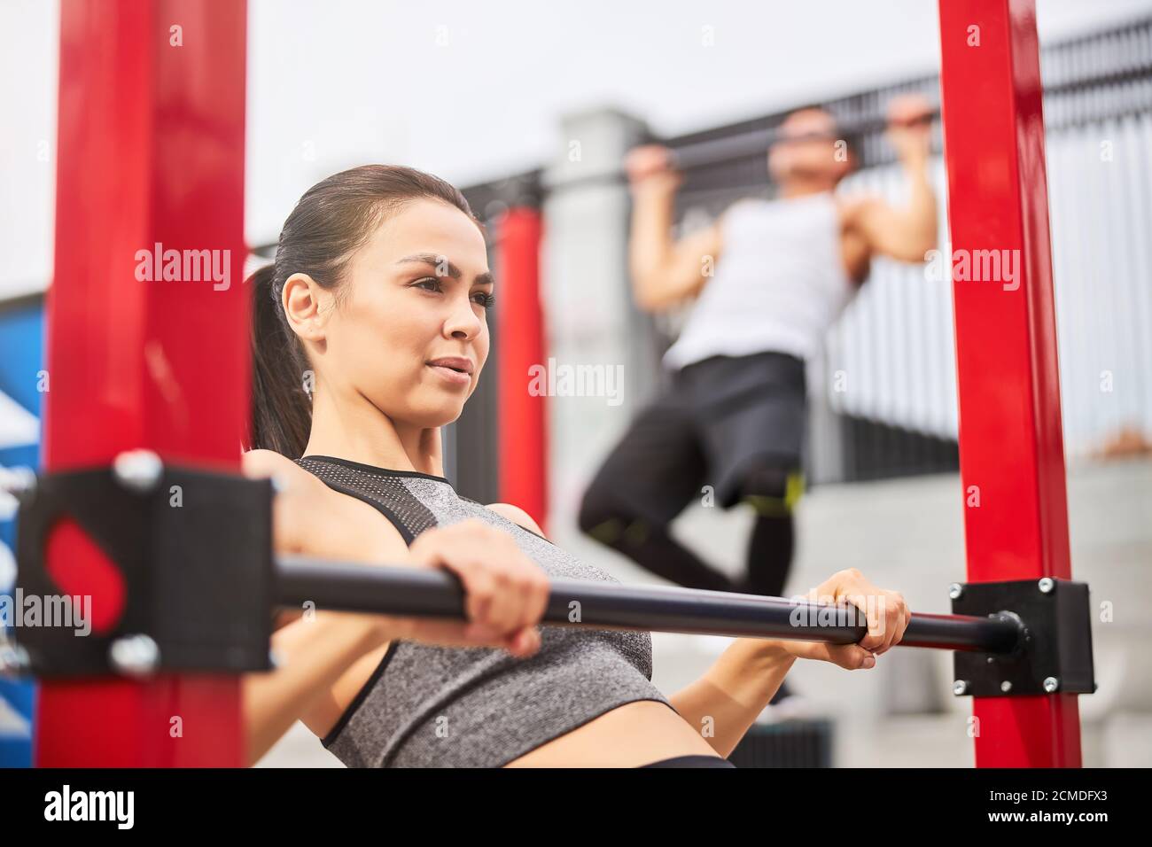 Motivated young couple training together on sports ground Stock Photo ...