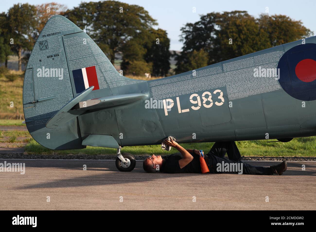 David Ratcliffe cleans the underside of the "Thank You NHS" Spitfire at ...