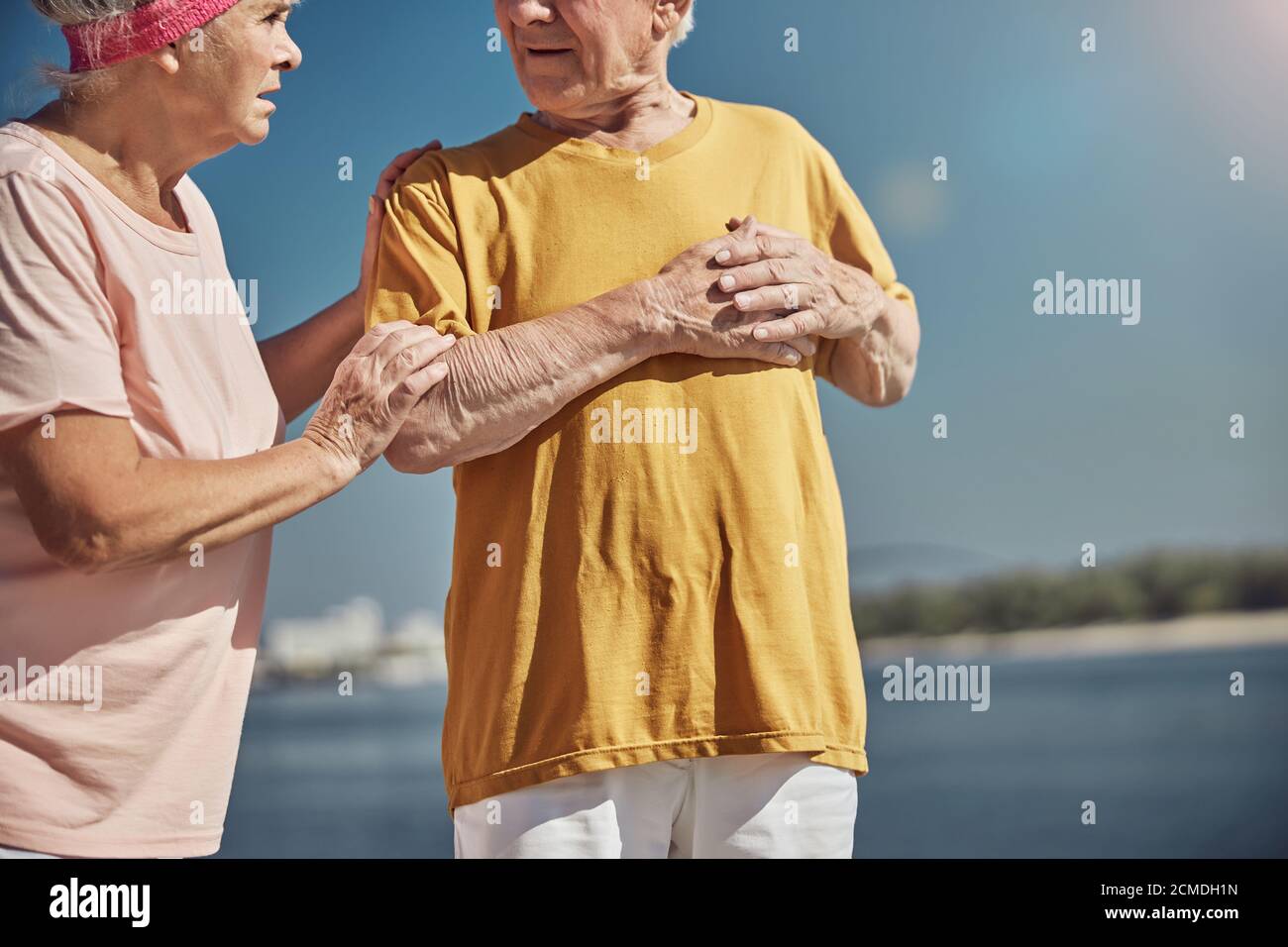 Man pressing his hand to the chest Stock Photo - Alamy