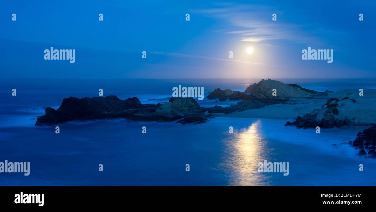 Moon setting over sea Stock Photo - Alamy