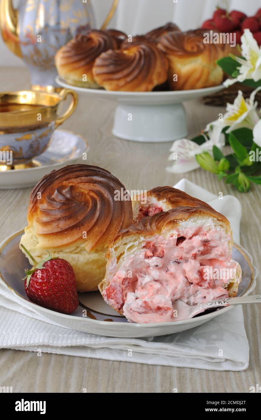 Eclairs with strawberry cream filling Stock Photo - Alamy