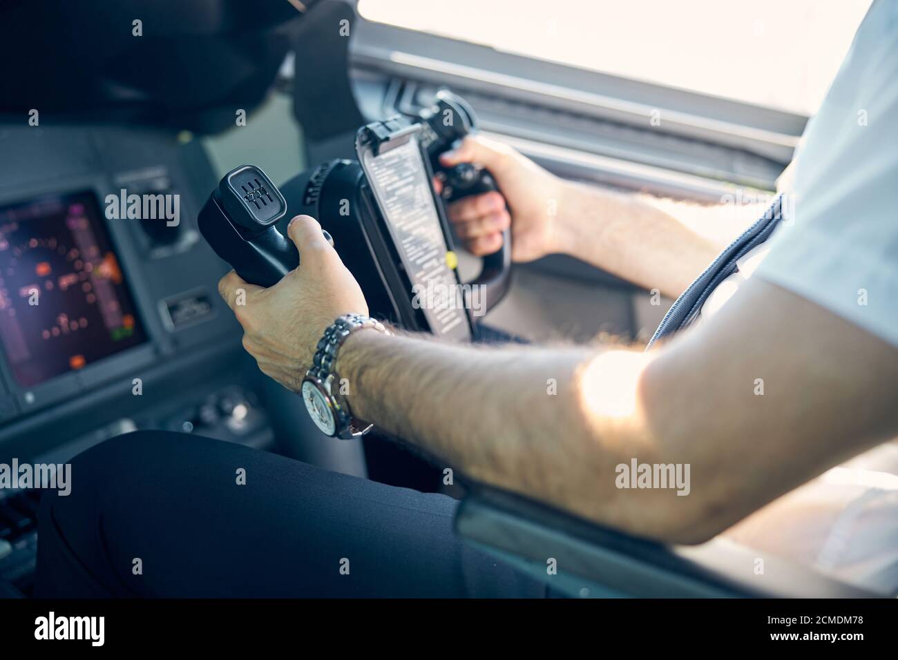 Male pilot is driving airplane in cockpit Stock Photo - Alamy
