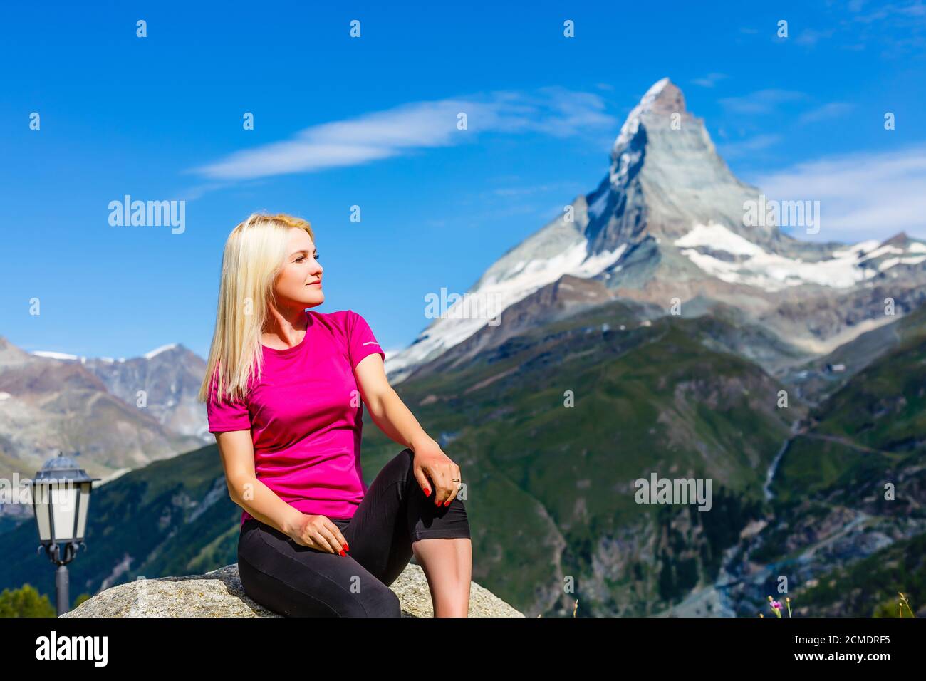 Woman hikers in the Alps, Matterhorn peak in Switzerland Stock Photo ...
