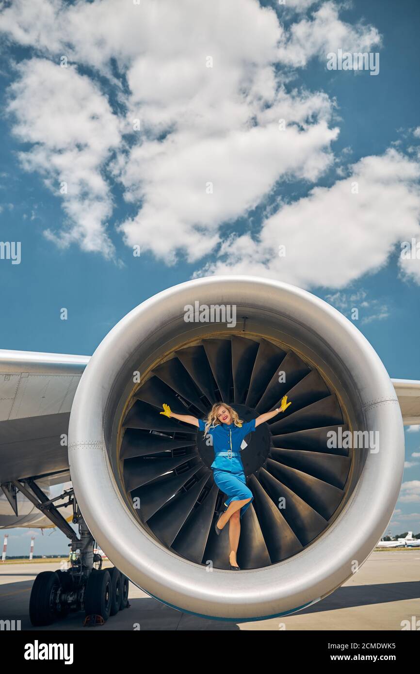 Beautiful young stewardess standing on plane engine Stock Photo - Alamy