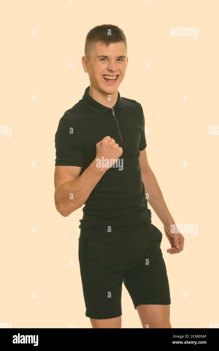 Young happy Caucasian man smiling and looking motivated Stock Photo - Alamy