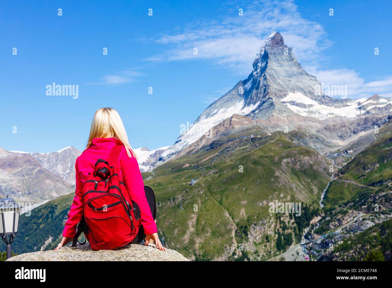 Woman hikers in the Alps, Matterhorn peak in Switzerland Stock Photo ...