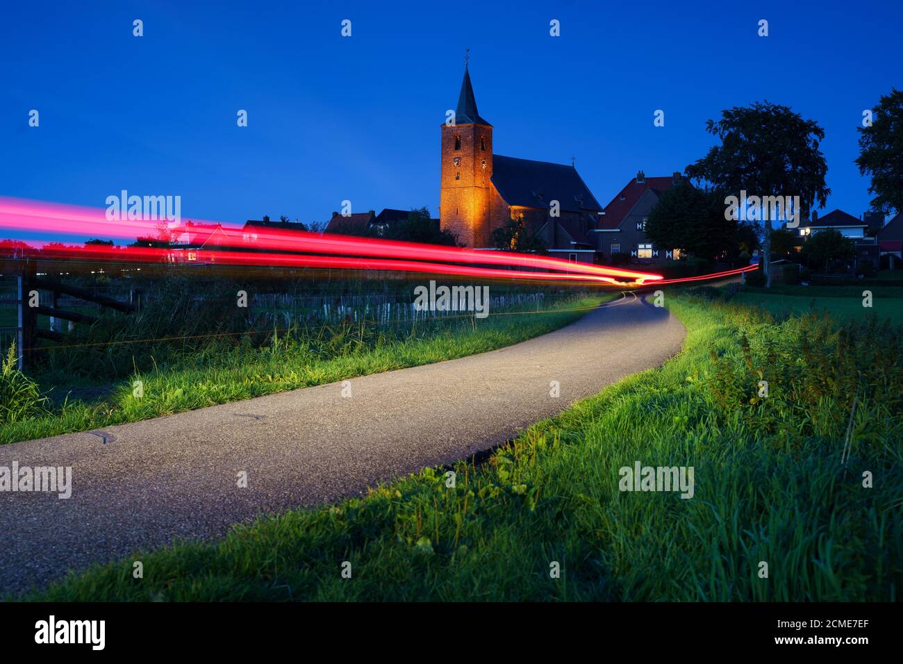 Medieval church in the floodplains on a dike of a Dutch river landscape ...