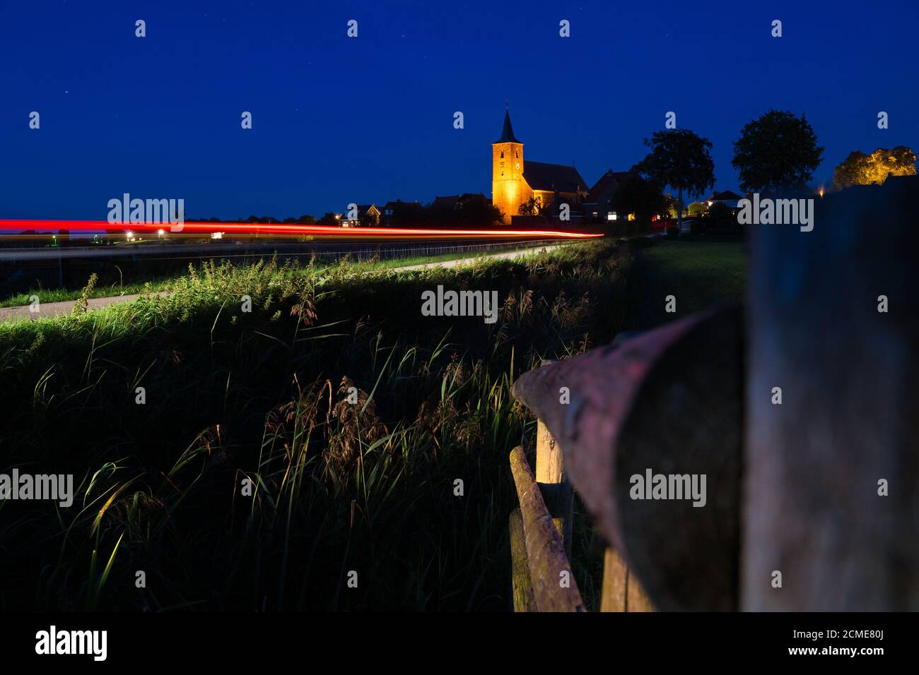 Medieval church in the floodplains on a dike of a Dutch river landscape ...