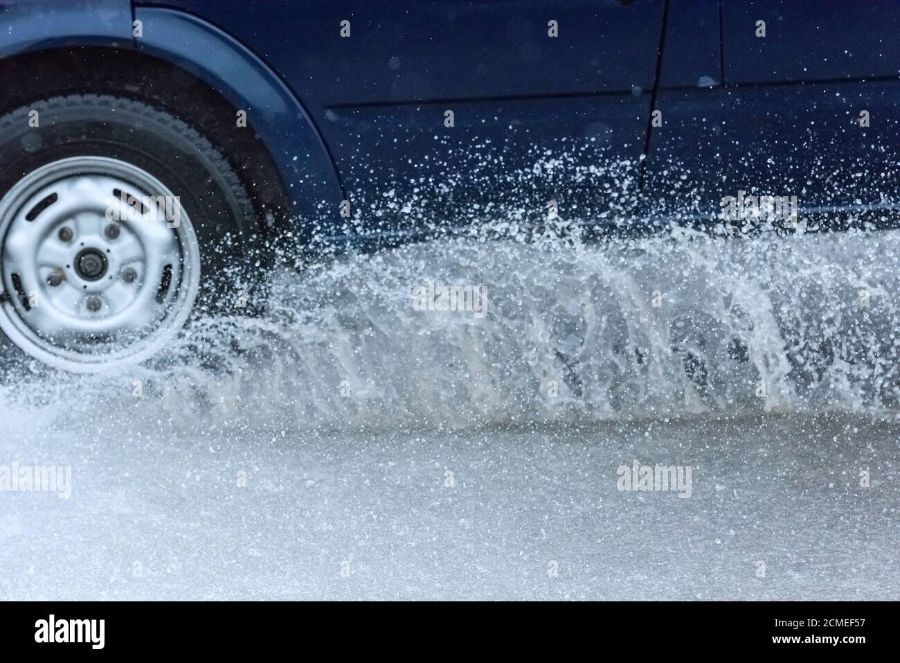 car rain puddle splashing water Stock Photo - Alamy