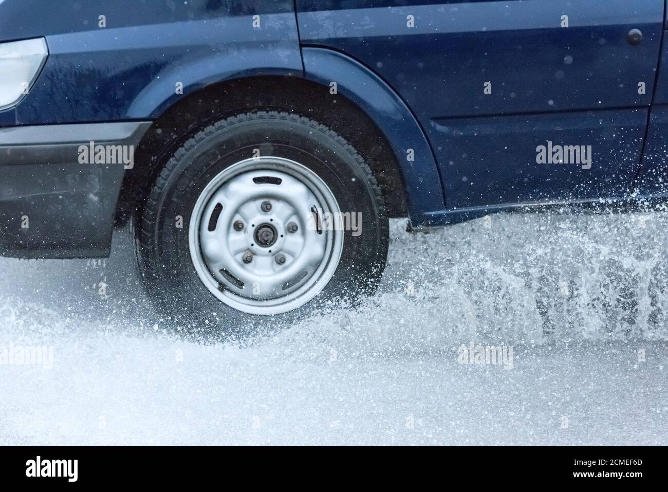 car rain puddle splashing water Stock Photo - Alamy