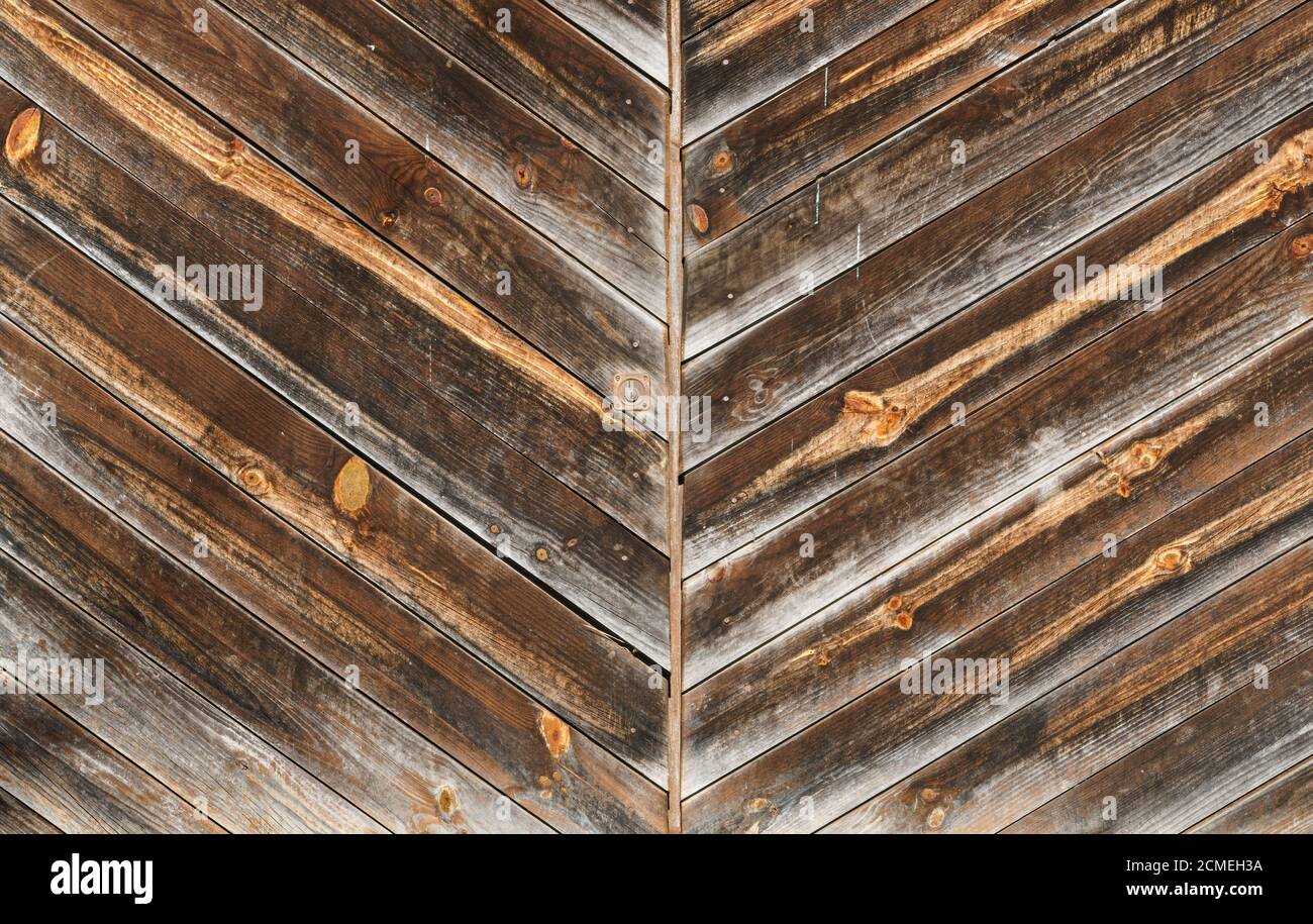 Detail of old unpainted wooden door with diagonal slats and a lot of ...