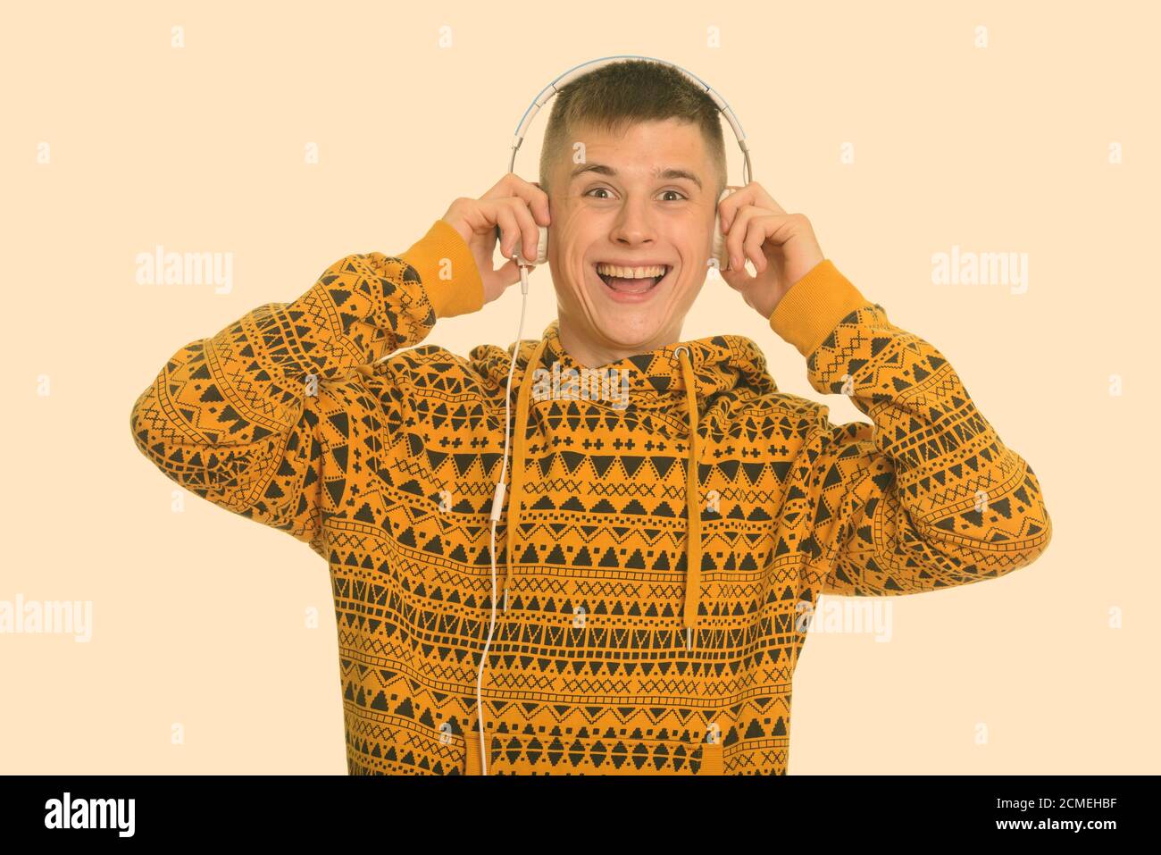 Young happy Caucasian man smiling while listening to music Stock Photo ...