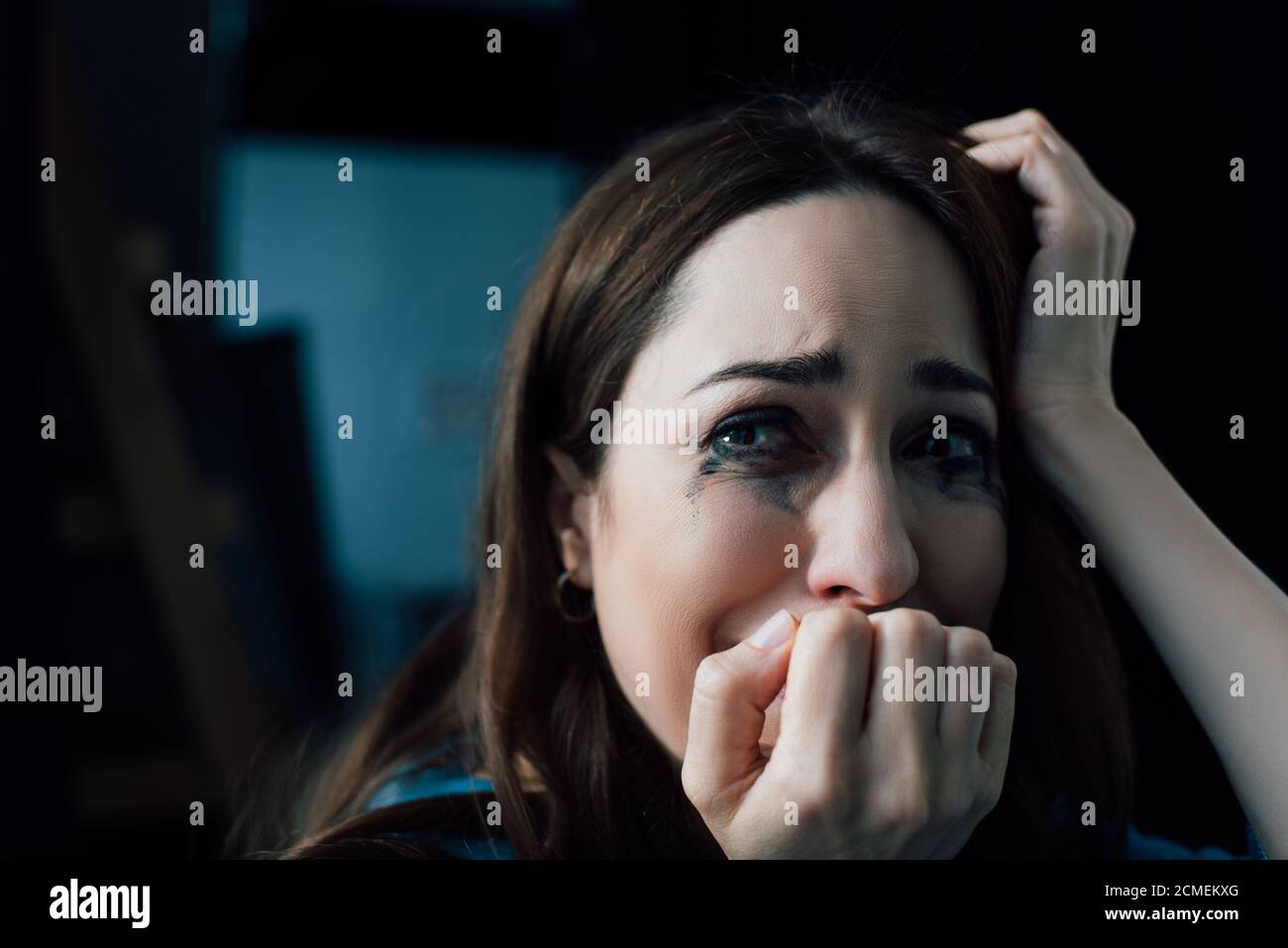 Brunette Woman With Flowed Mascara Crying And Looking Away At Home