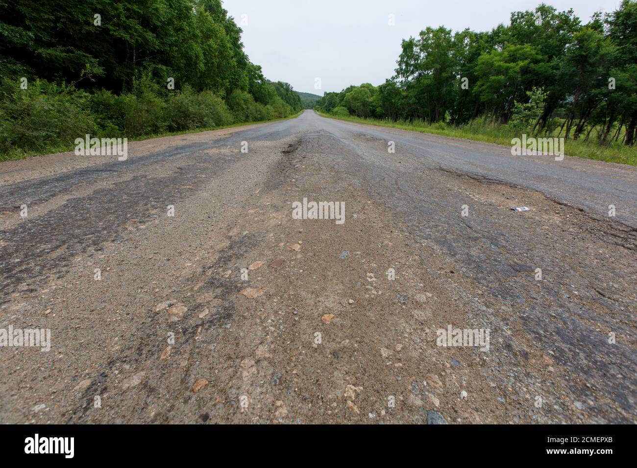 Very bad road in Russia. The asphalt road is all in holes in the middle ...