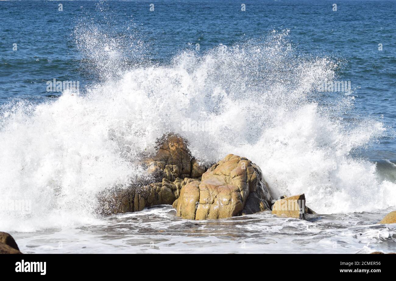 Wave bursting on coastal rocks hi-res stock photography and images - Alamy