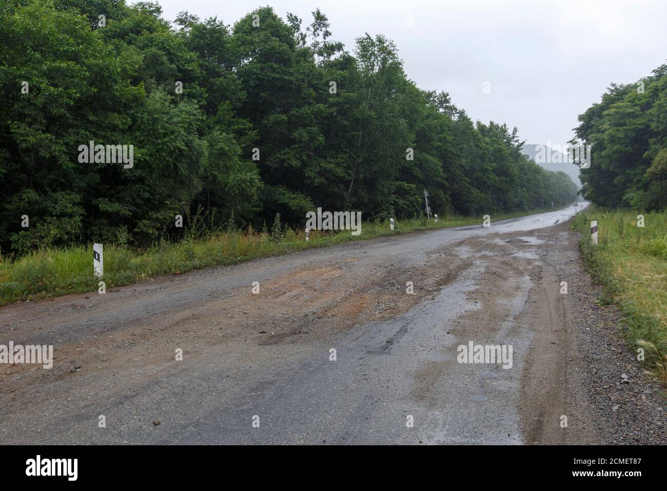 Very bad road in Russia. The asphalt road is all in holes in the middle ...