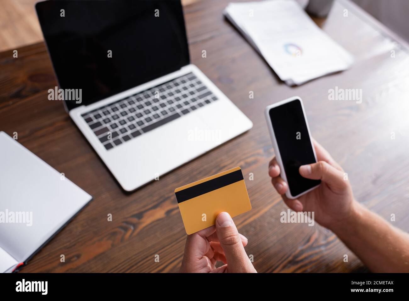 Cropped view of businessman holding smartphone with blank screen and ...