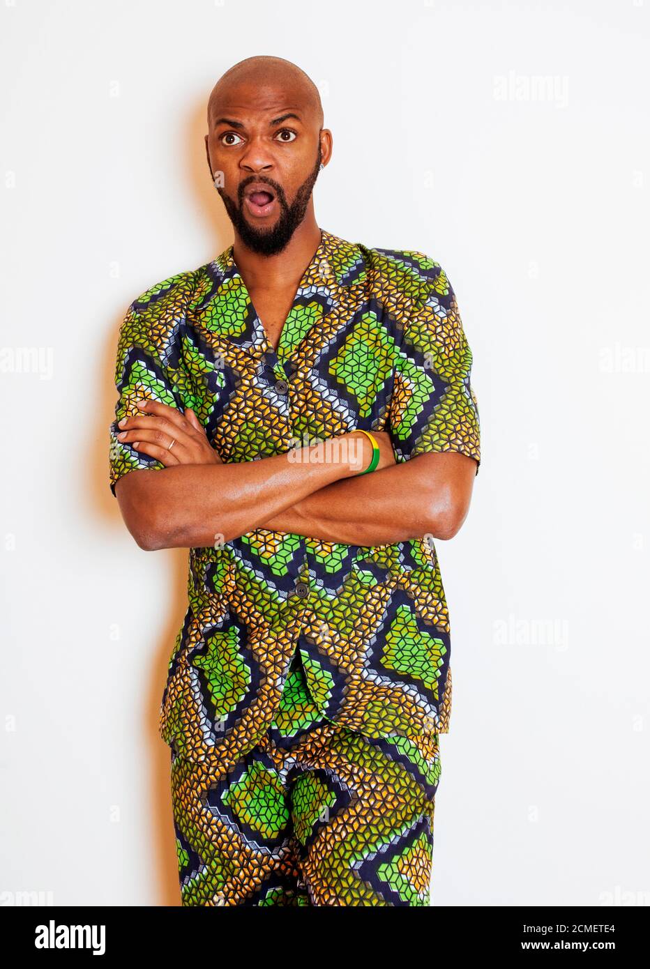 portrait of young handsome african man wearing bright green national ...