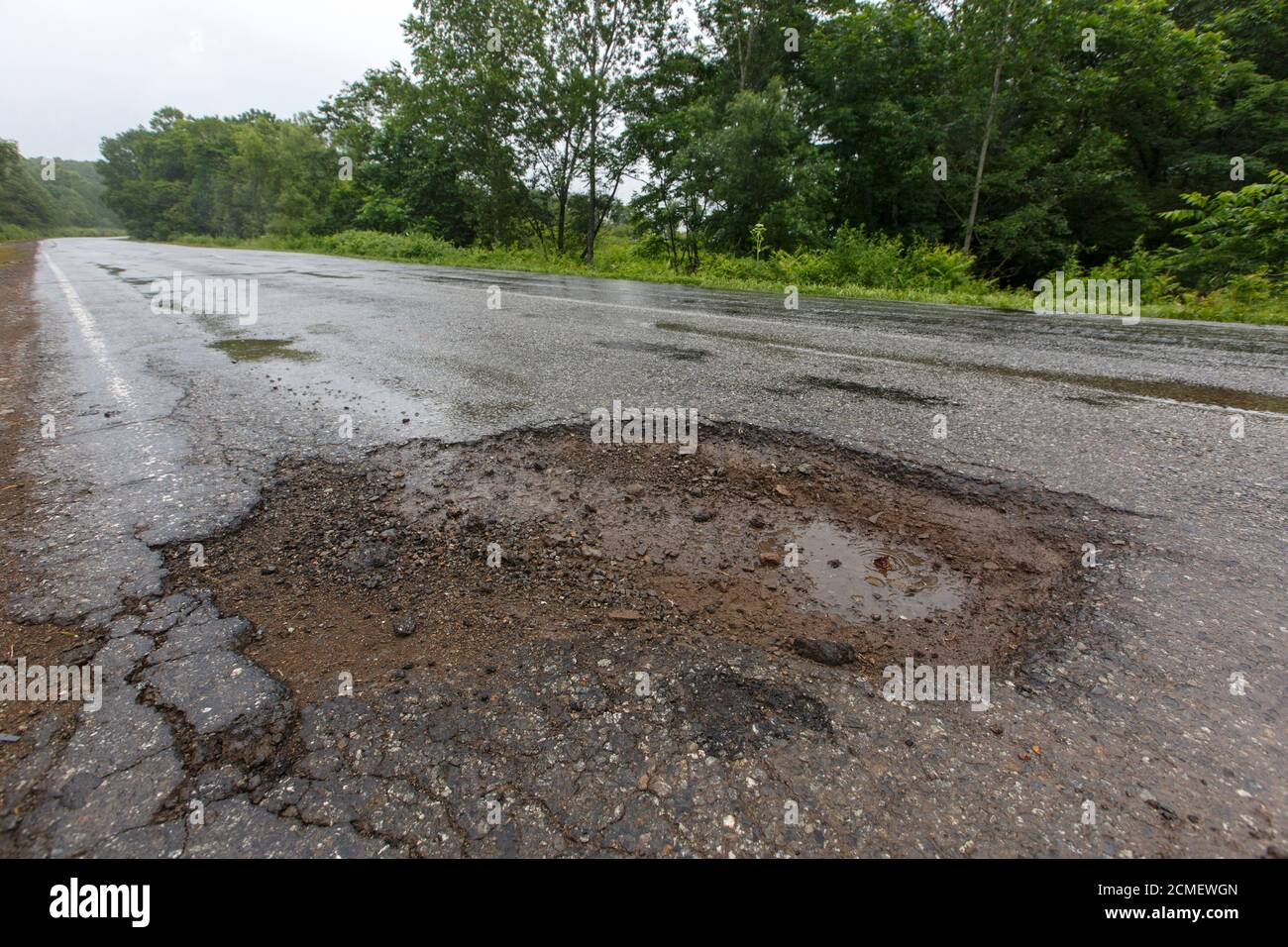Very bad road in Russia. The asphalt road is all in holes in the middle ...
