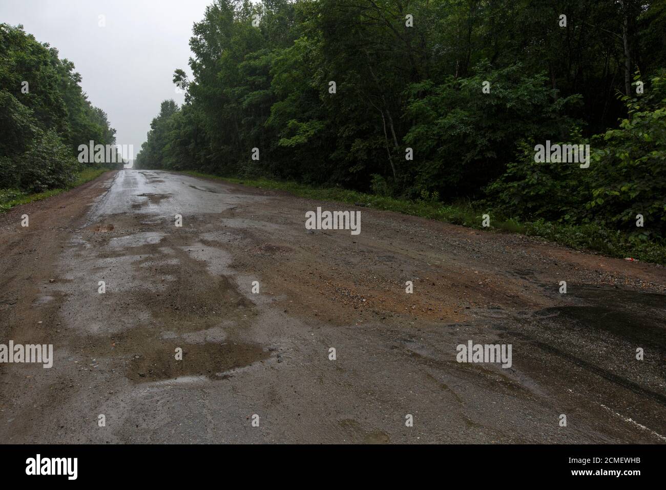Very bad road in Russia. The asphalt road is all in holes in the middle ...