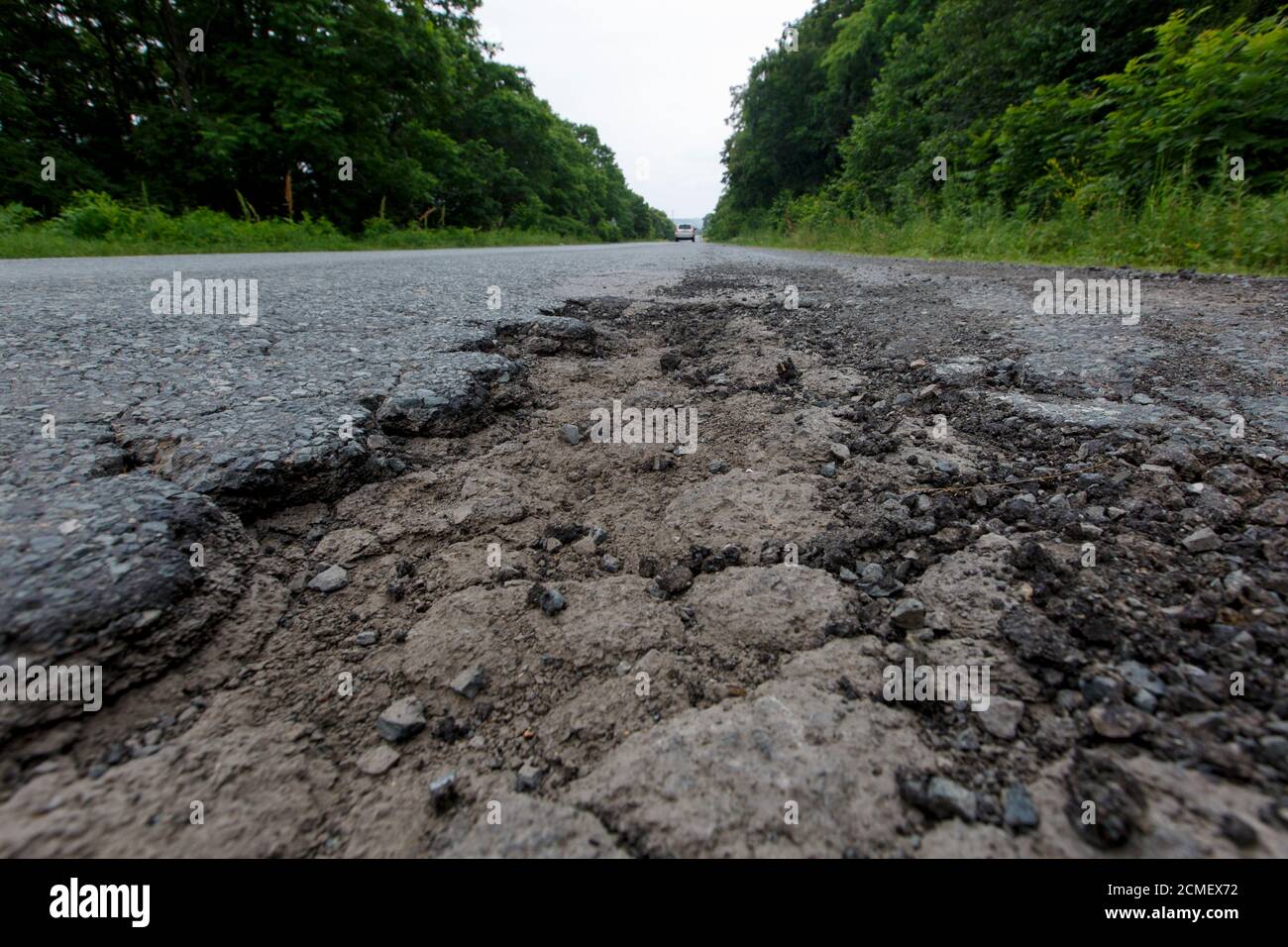 Very bad road in Russia. The asphalt road is all in holes in the middle ...