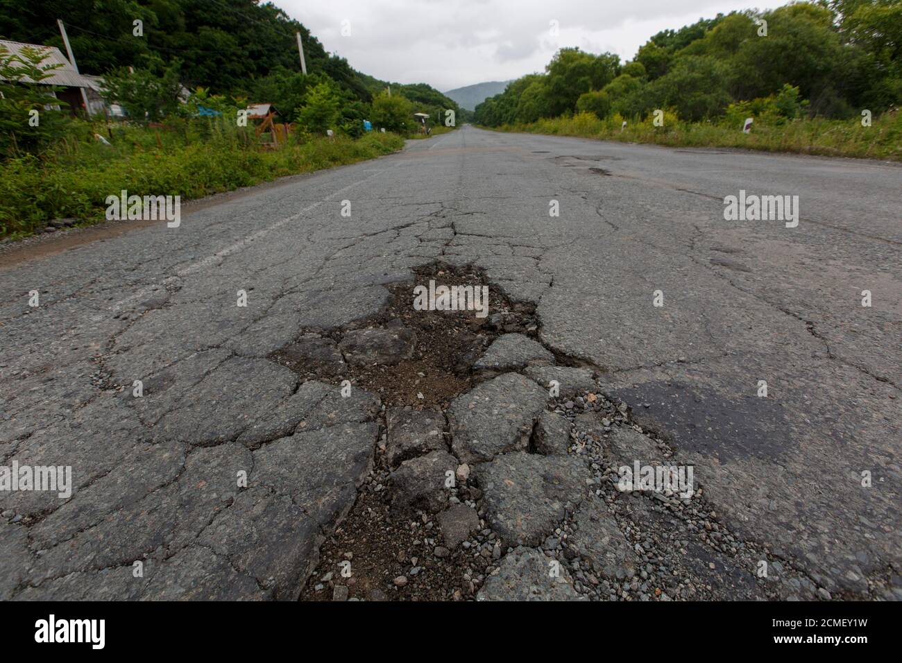 Very bad road in Russia. The asphalt road is all in holes in the middle ...