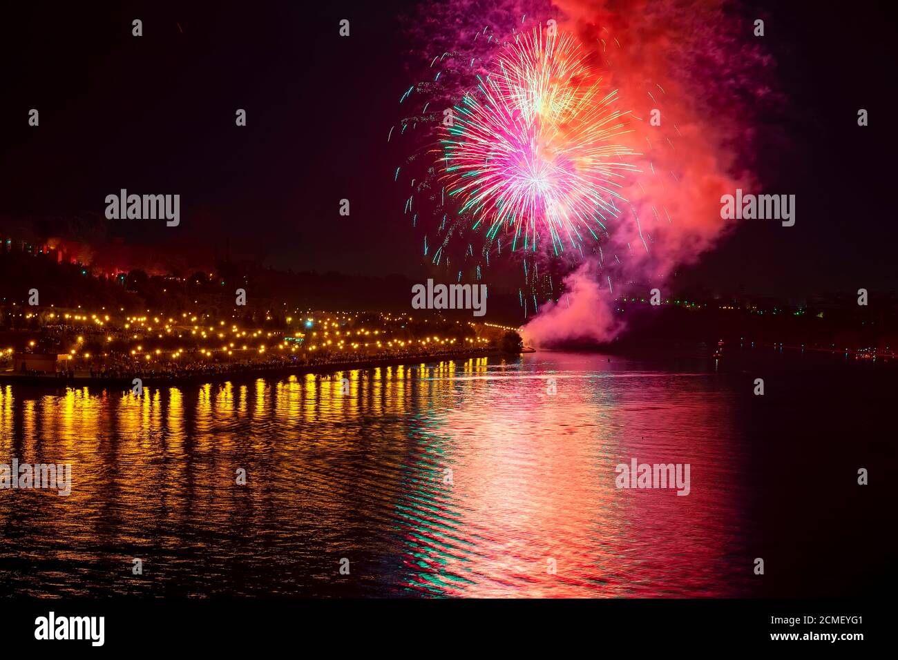Vivid red fireworks with sparks on dark sky. Explosive pyrotechnic ...
