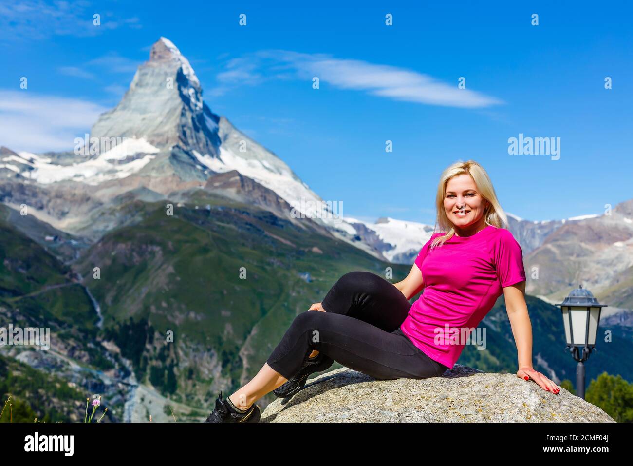 Woman hikers in the Alps, Matterhorn peak in Switzerland Stock Photo ...