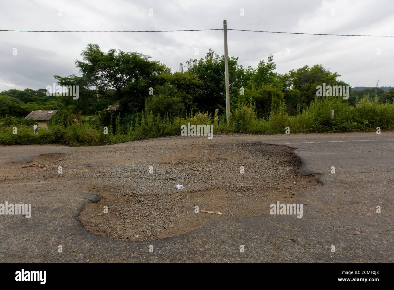 Very bad road in Russia. The asphalt road is all in holes in the middle ...