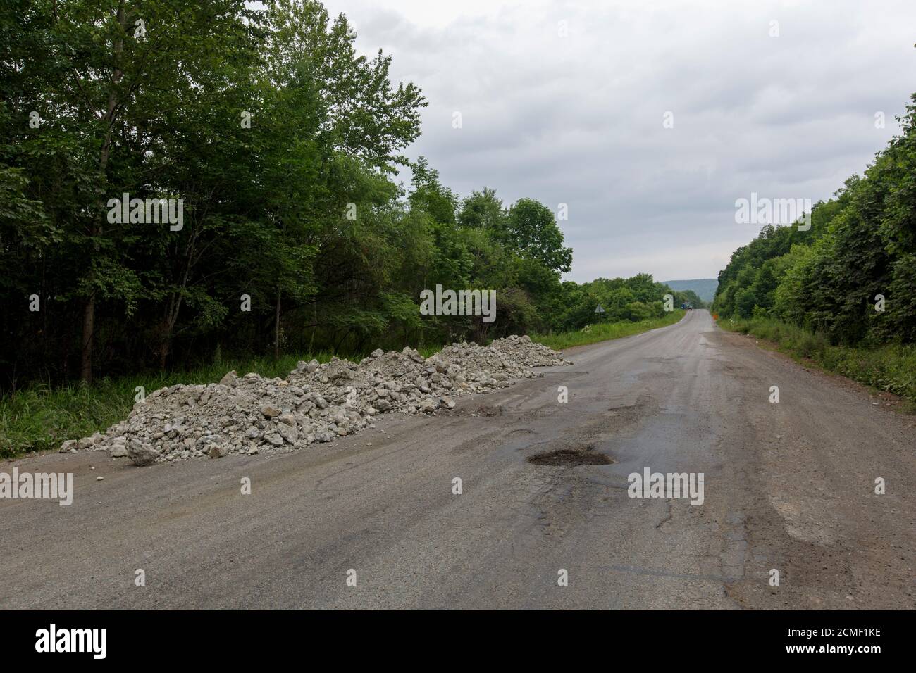 Very bad road in Russia. The asphalt road is all in holes in the middle ...