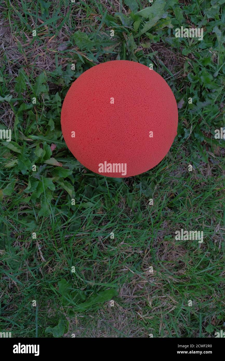 Vertical shot of a small red ball Stock Photo - Alamy