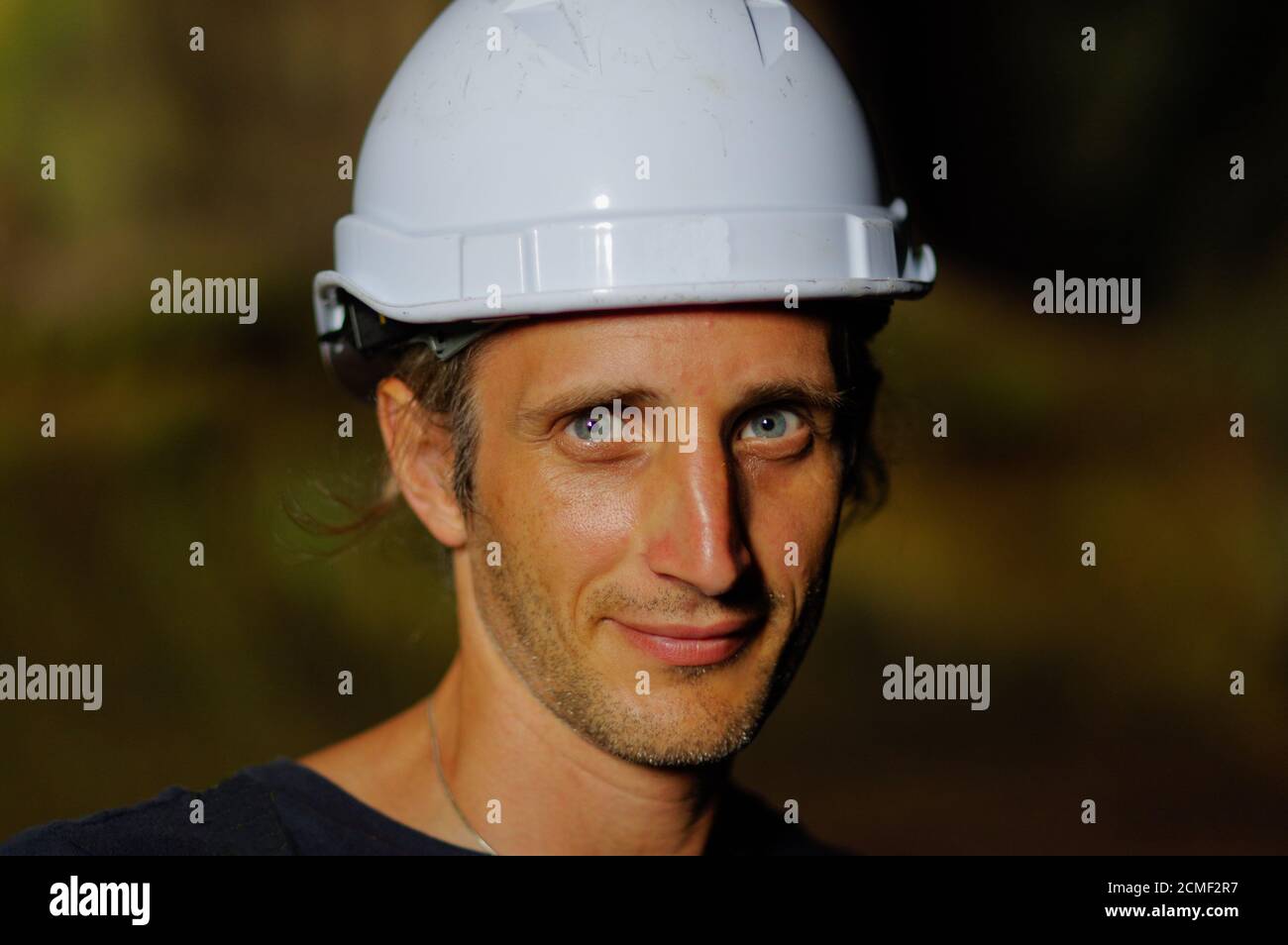 portrait of a worker with white helmet on head, nature background Stock ...