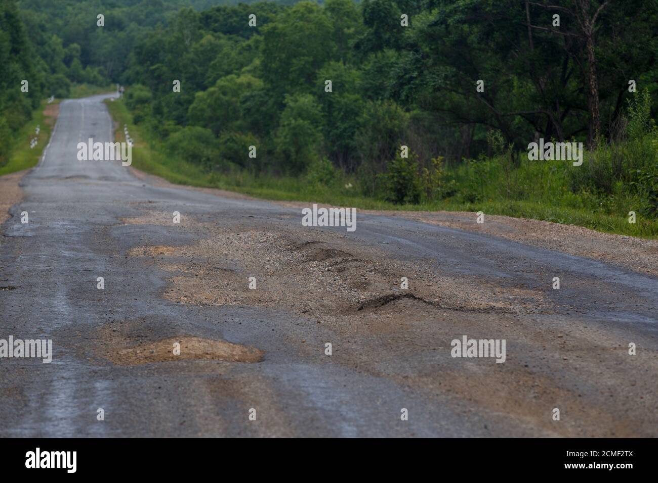 Very bad road in Russia. The asphalt road is all in holes in the middle ...