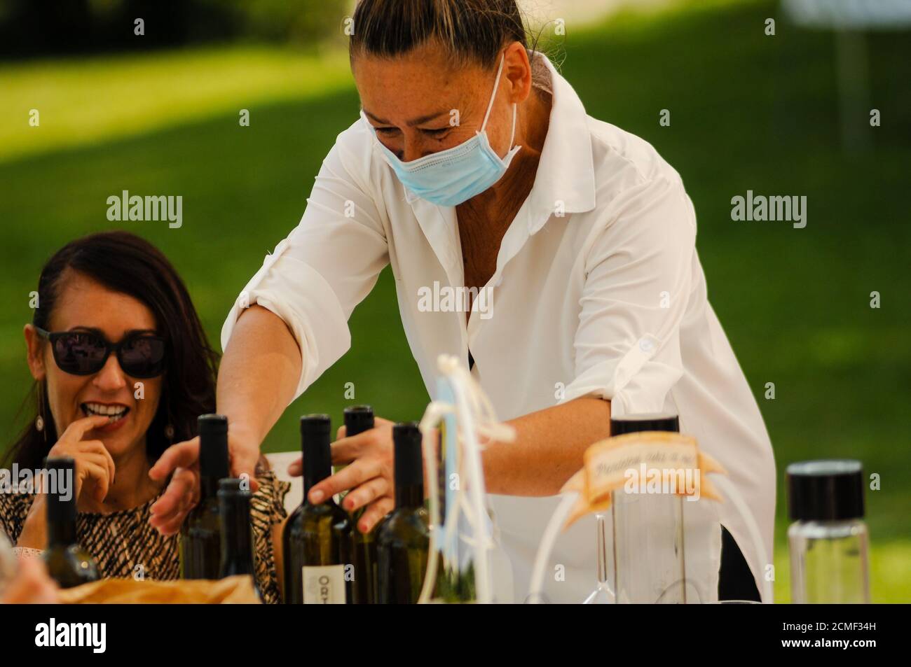 Waiter at wedding event protecting with a face mask while working ...