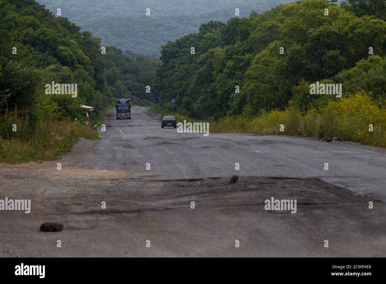 Very bad road in Russia. The asphalt road is all in holes in the middle ...