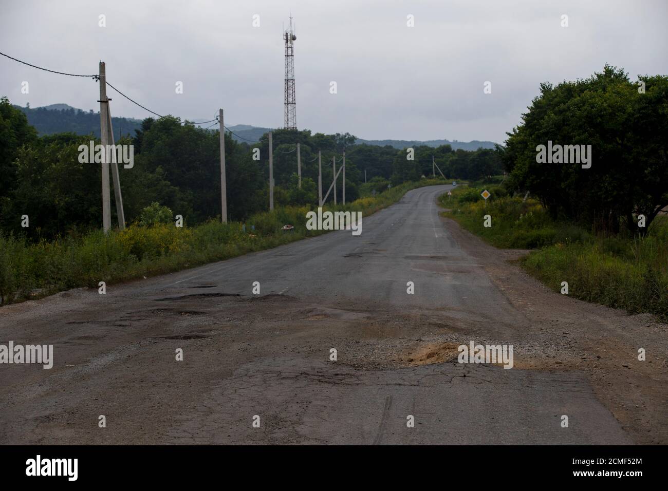 Very bad road in Russia. The asphalt road is all in holes in the middle ...