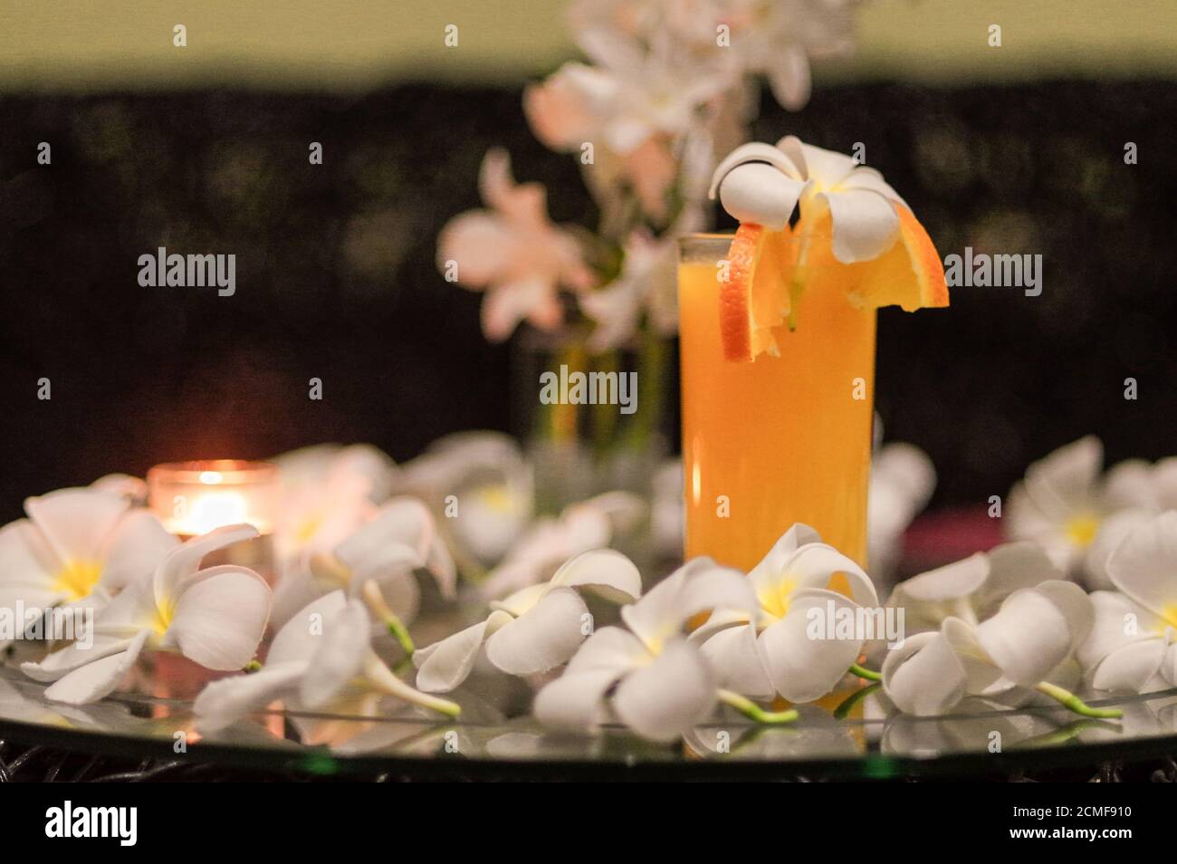 Freshly squeezed fresh orange juice with Magnolia blossoms on the glas ...