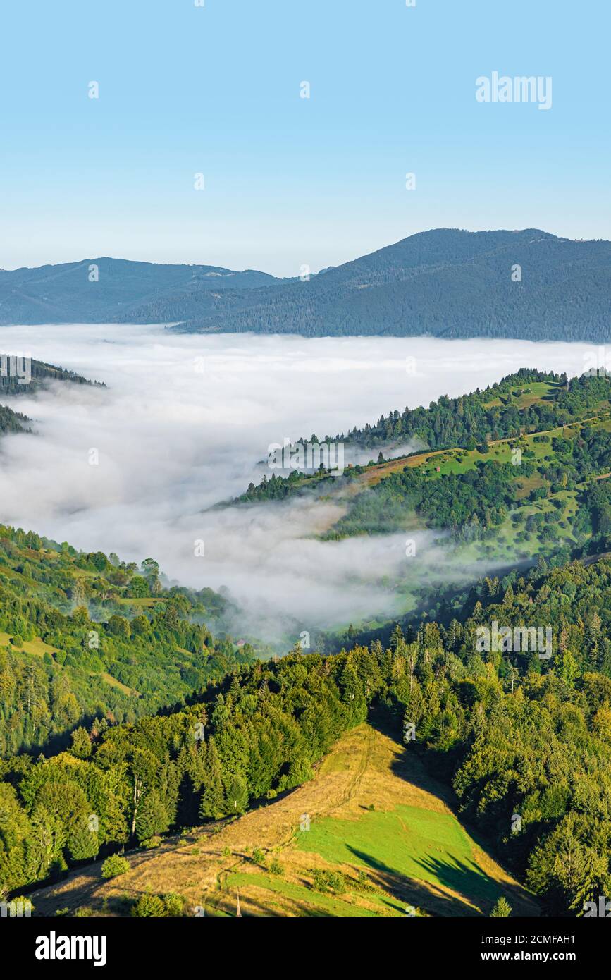 View of the mountain landscape and the mist-shrouded valley Stock Photo ...